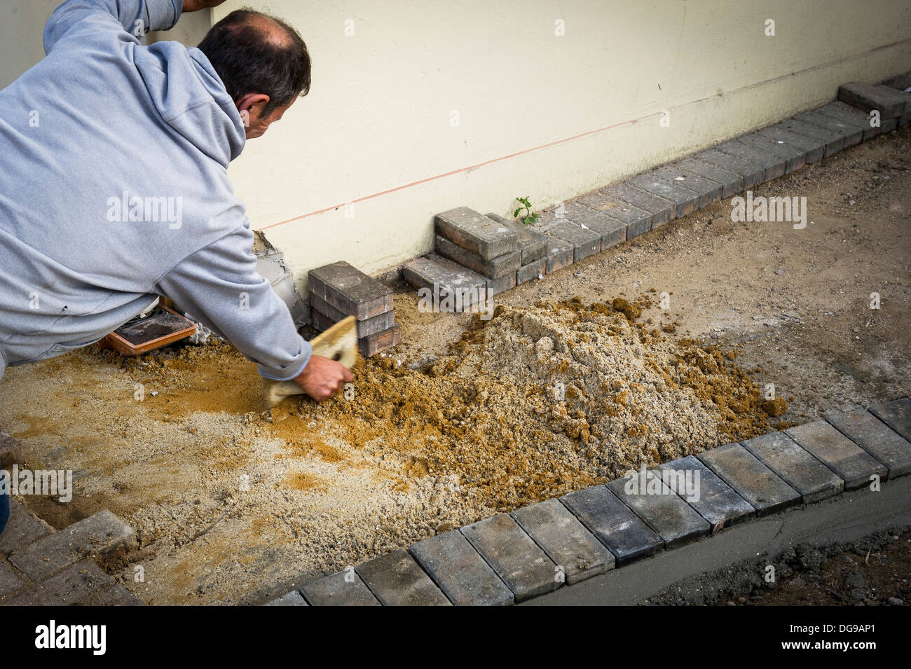 A block paver laying a block pathway Stock Photo - Alamy