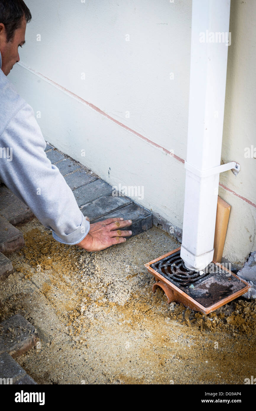 A block paver laying a block pathway Stock Photo - Alamy