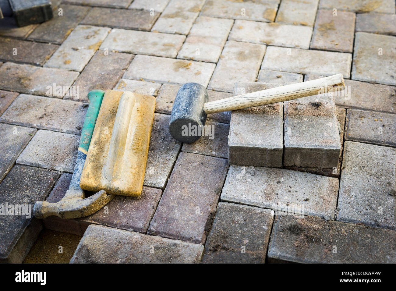 Tools used to lay a block paving pathway Stock Photo - Alamy