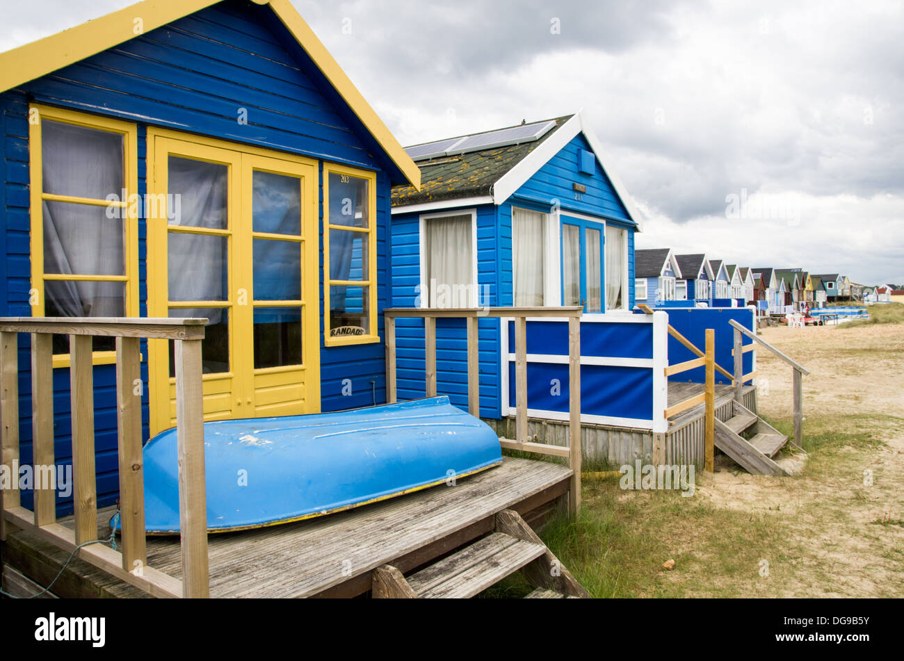 A row of beach huts on Hengistbury head beach. Family holiday seaside ...