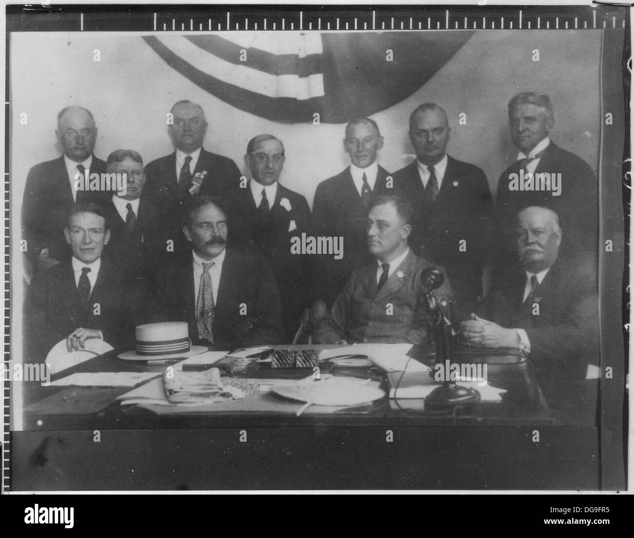 The photograph shows Franklin D. Roosevelt with several members of the ...