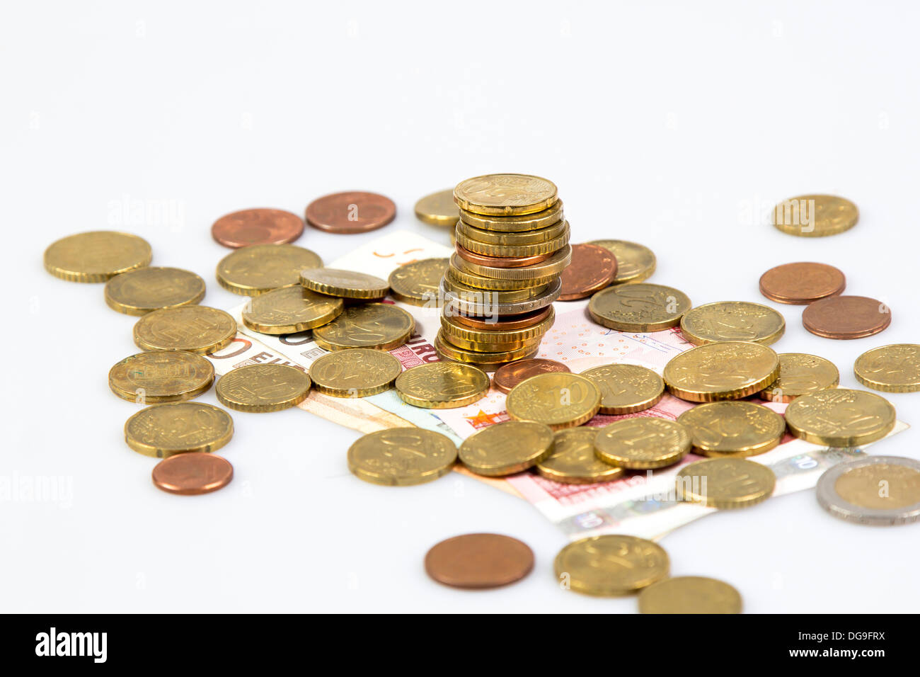 Stacked and single Euro coins and some notes isolated on white ...