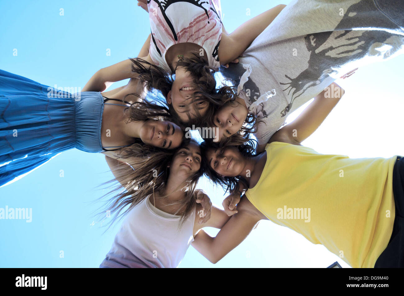 group of five friends embracing, from below Stock Photo - Alamy