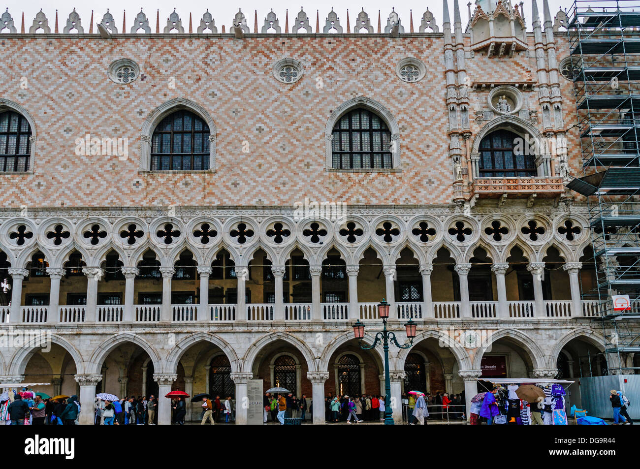 Tourists queue in the arcade to tour the inside of the Doge's Palace ...