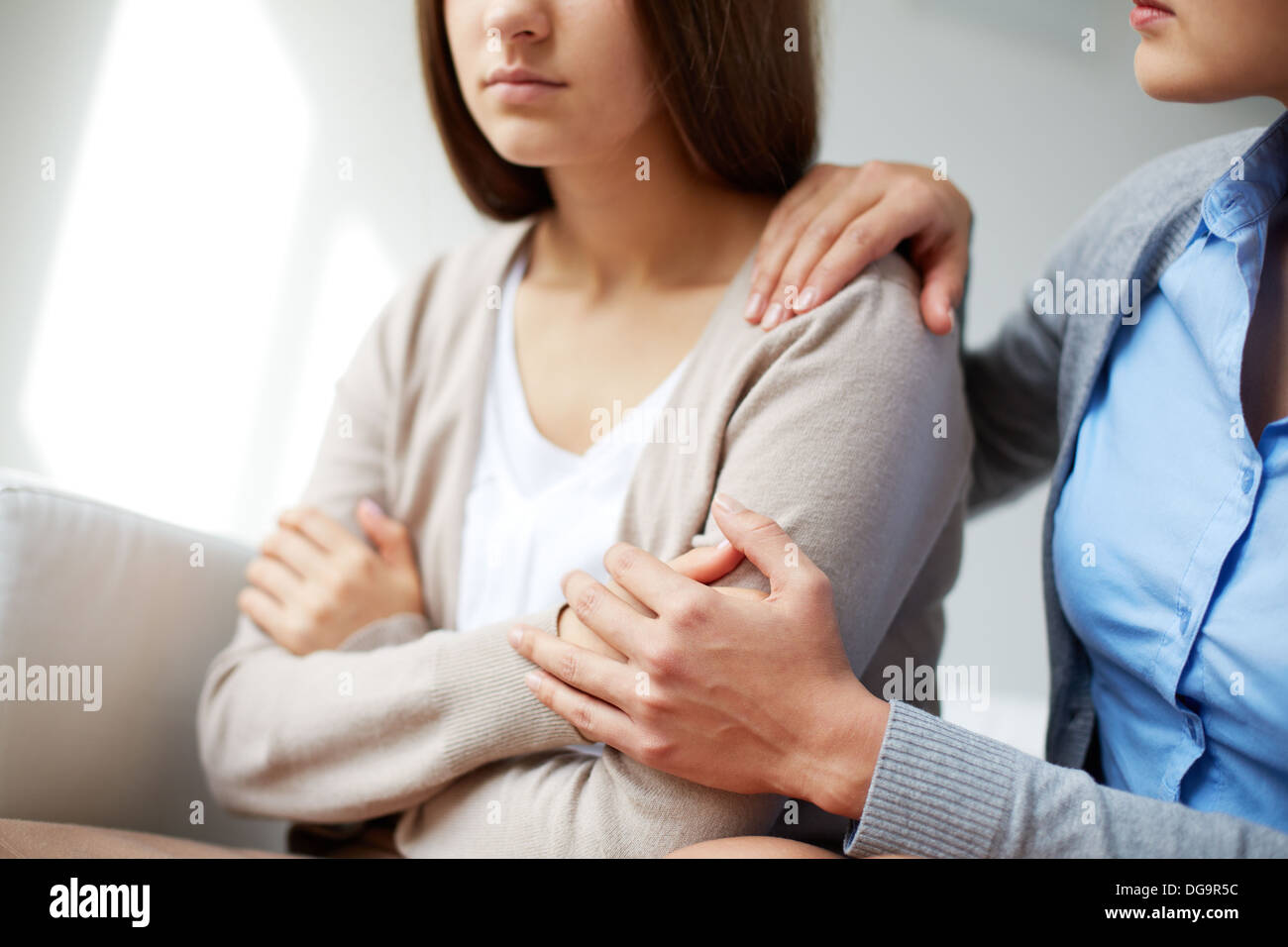Image of young psychiatrist comforting her sad patient Stock Photo - Alamy