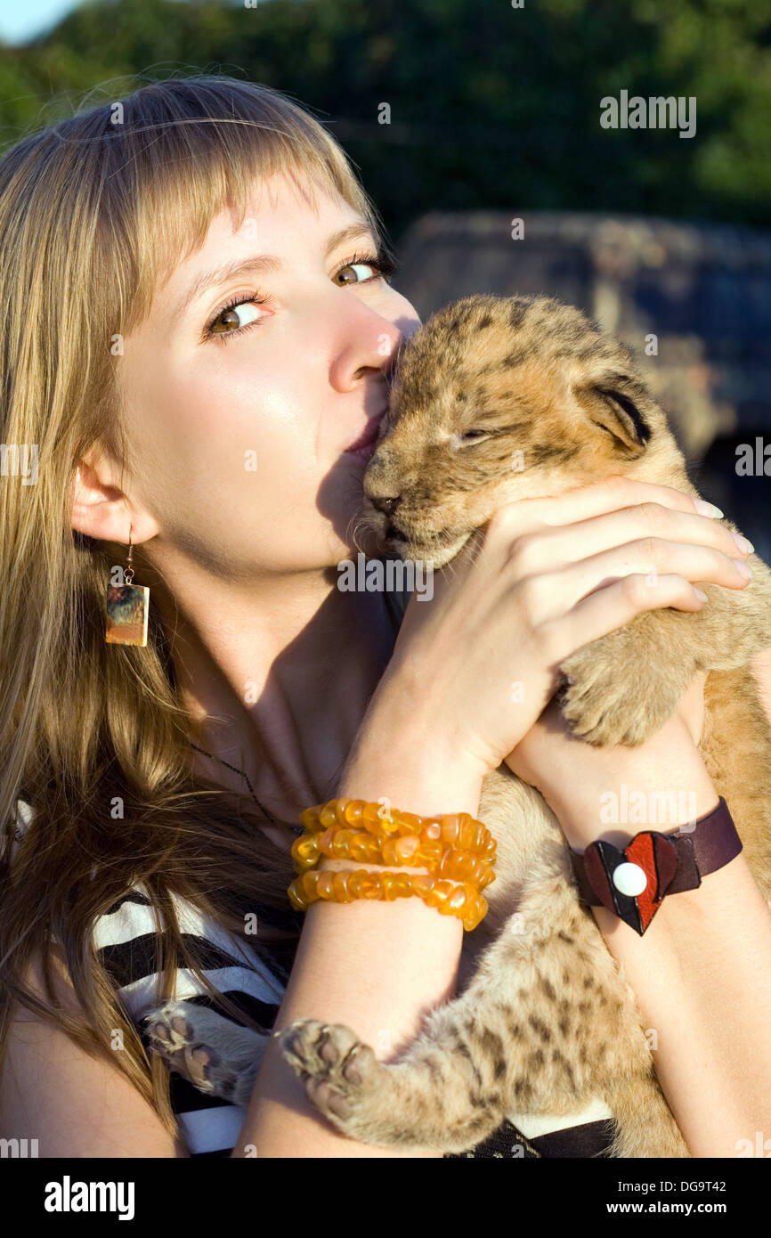 Portrait of beautiful woman with lion cub Stock Photo - Alamy