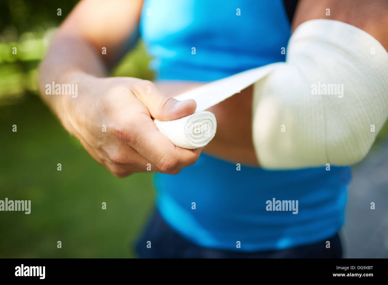 Close-up of male bandaging his arm Stock Photo - Alamy