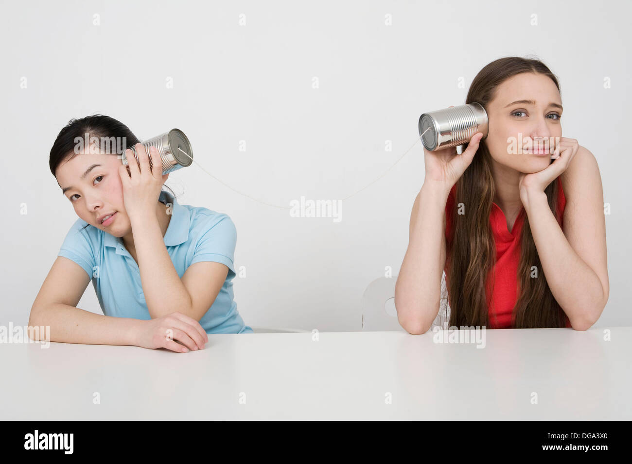 holding Disposable Cup against wall, listening Stock Photo - Alamy