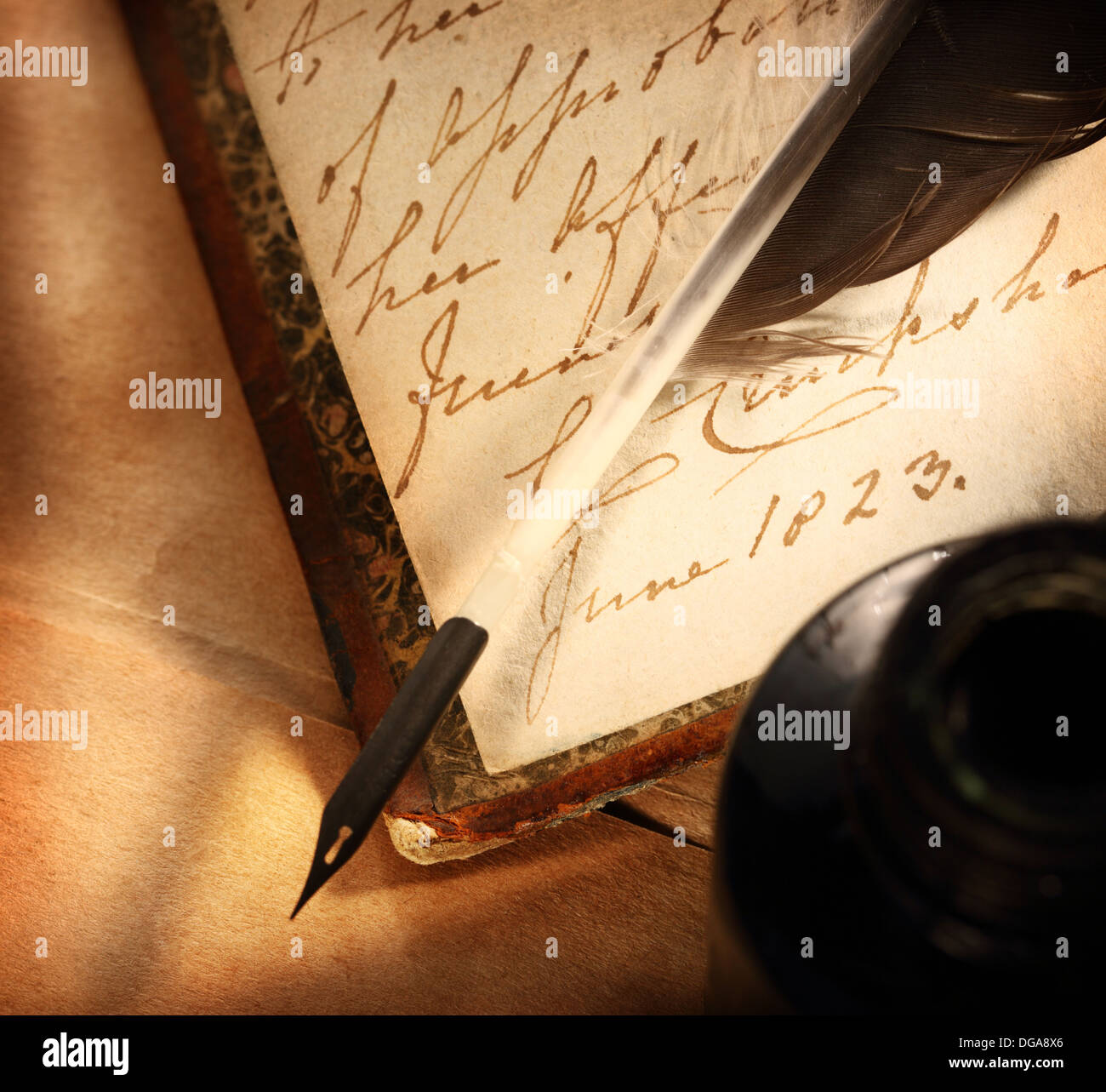 Old book with feather and inkpot Stock Photo - Alamy