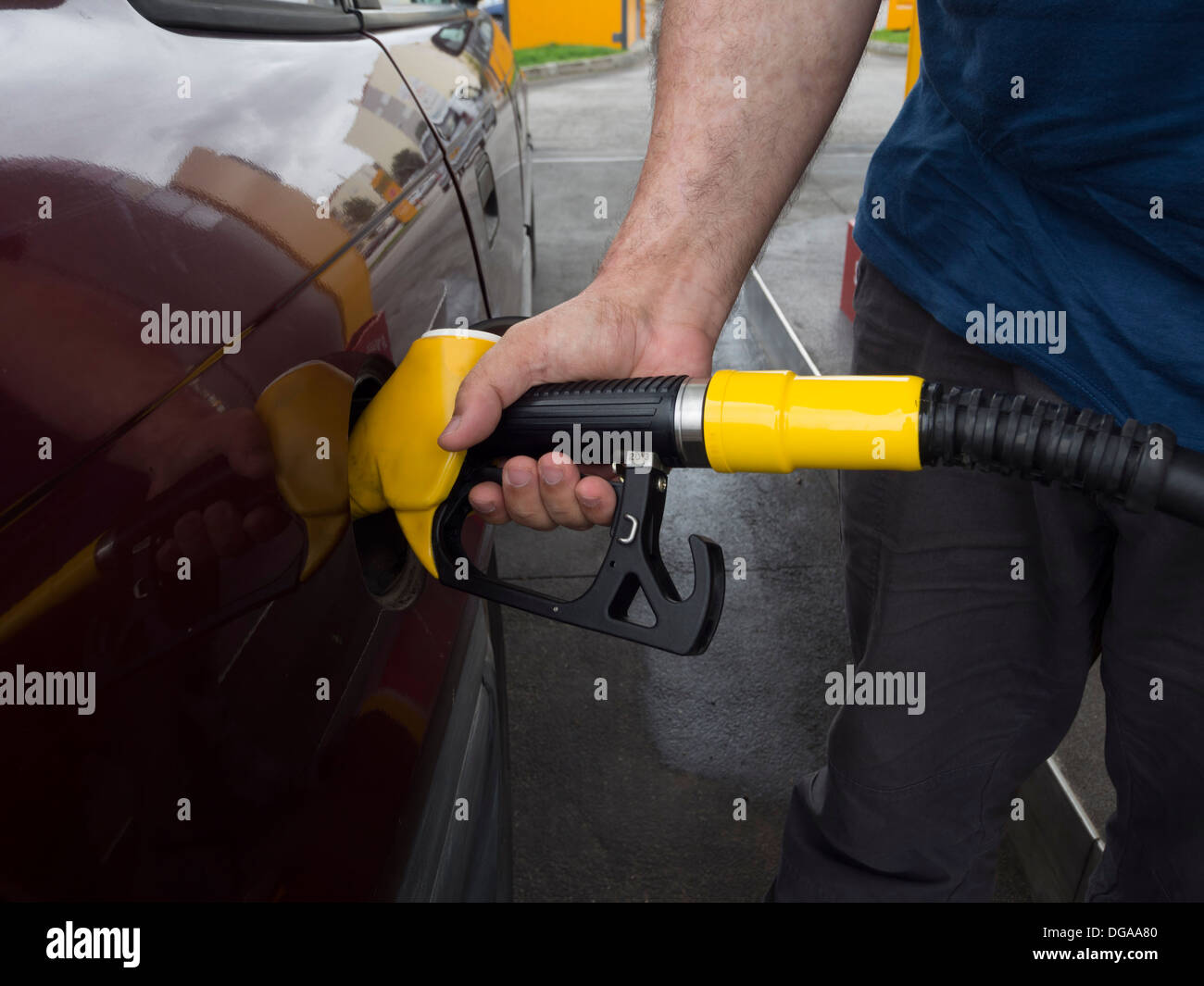Person pumping gas at a gas station Stock Photo - Alamy