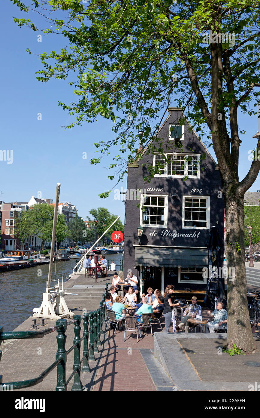 Terrace beside a lock in the canal in Amsterdam Stock Photo - Alamy