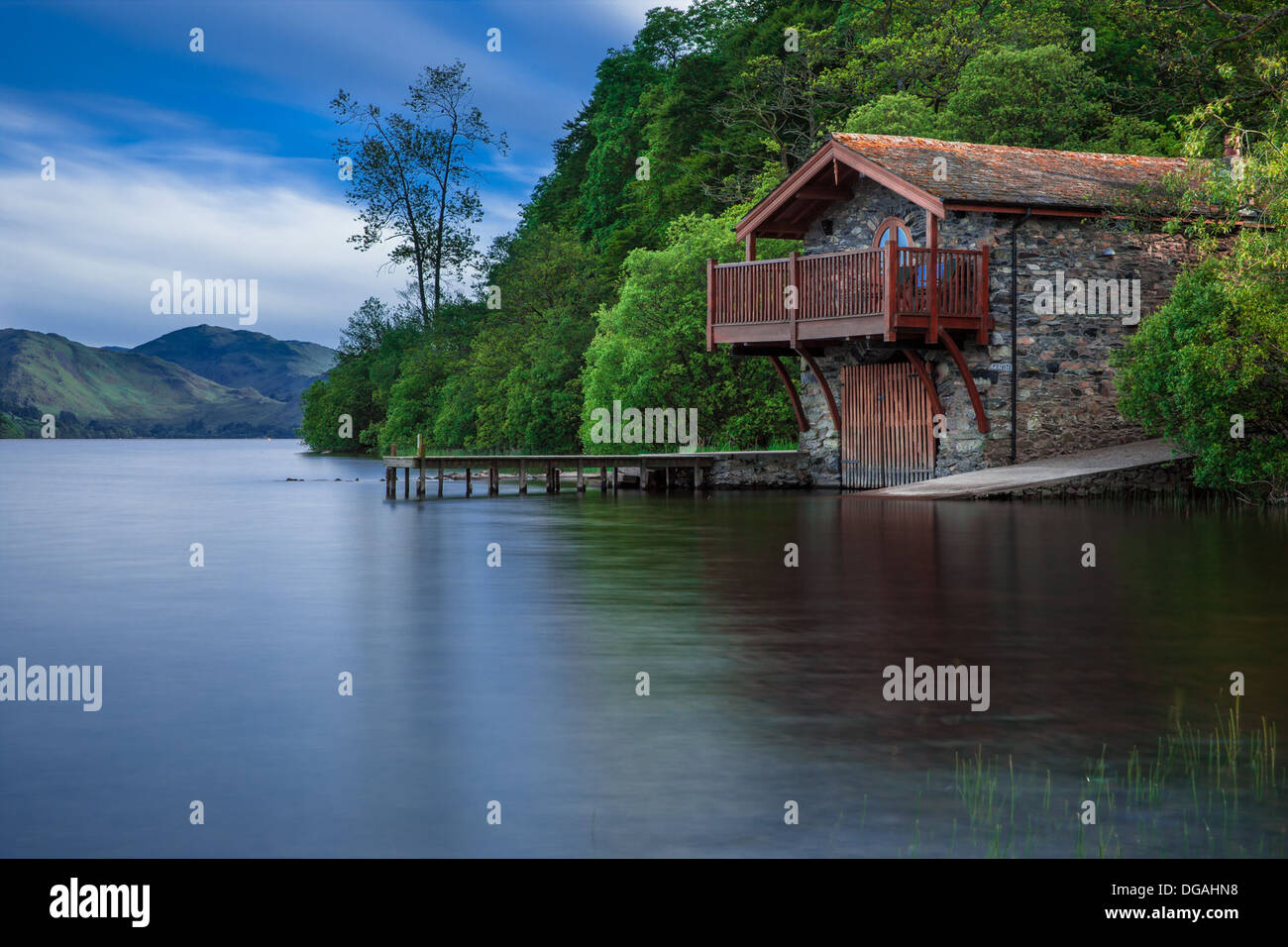 A picturesque boathouse cottage by the waters of Scotland, with a ...