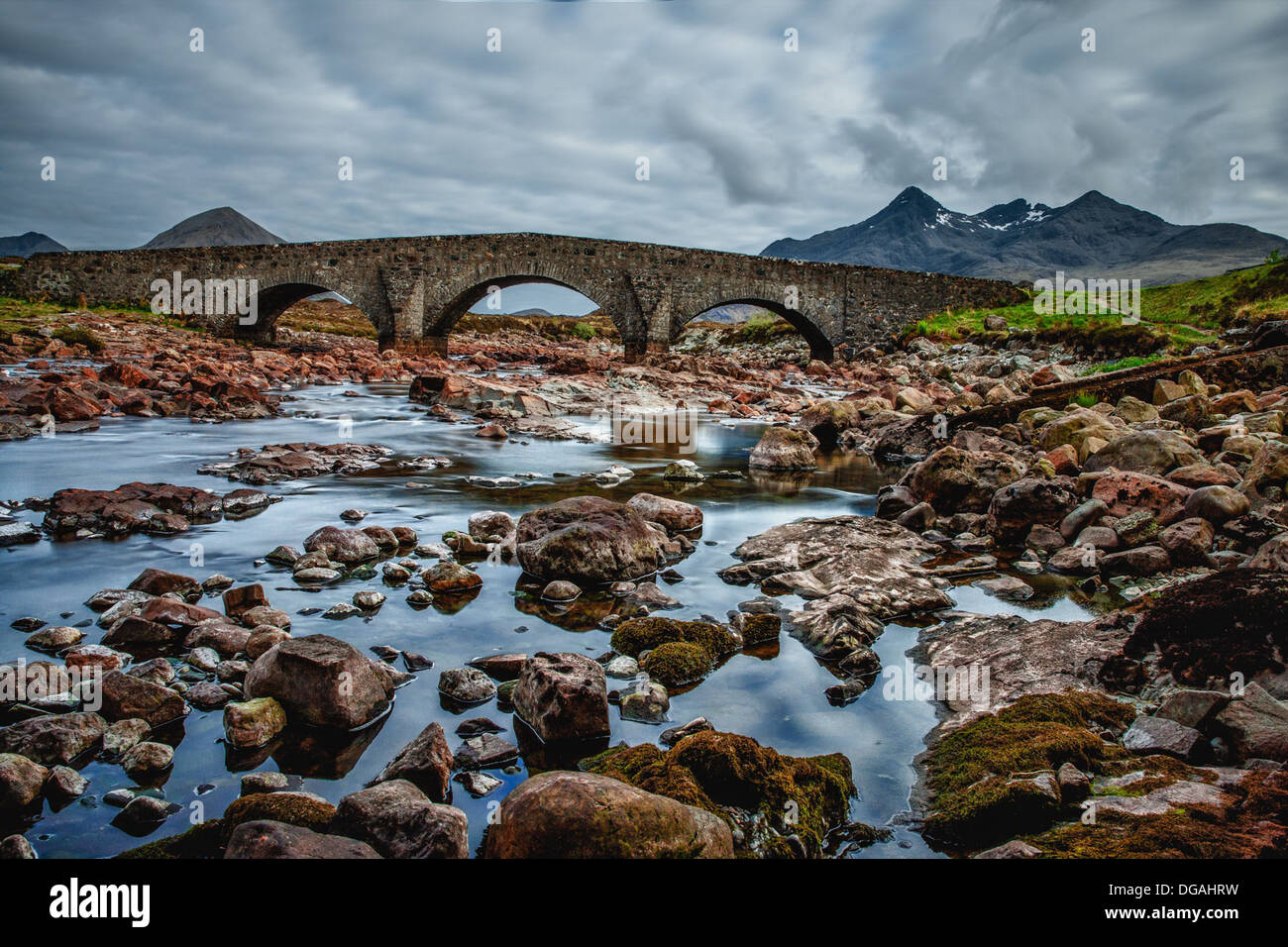This bridge in Scotland spans a body of blue water, with majestic ...