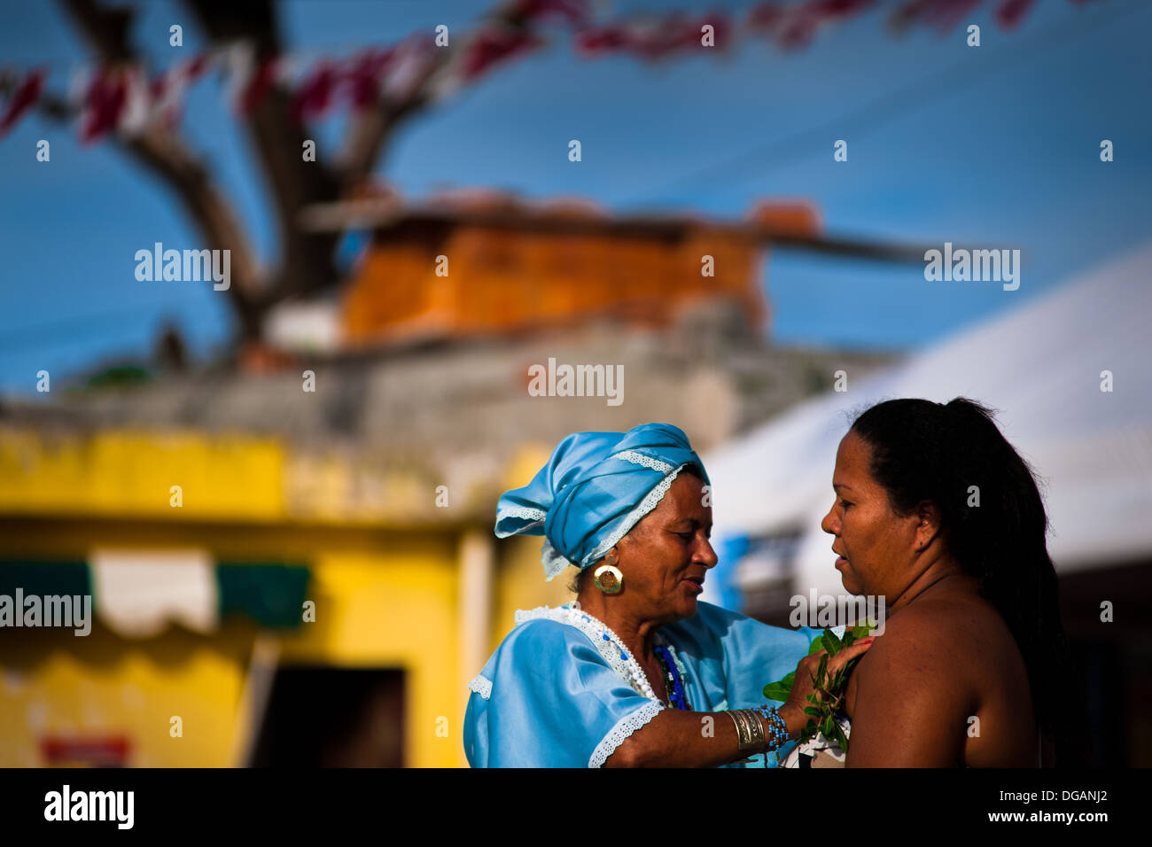 A Baiana woman performs a cleansing ritual, using the herbs, in front ...