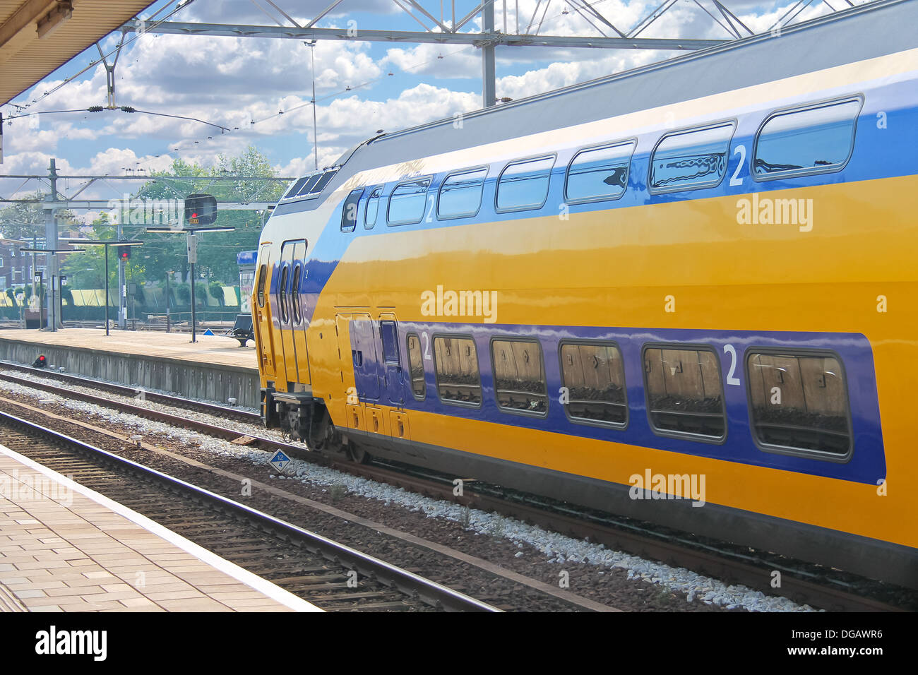 Arrival of the train at railway station Stock Photo - Alamy