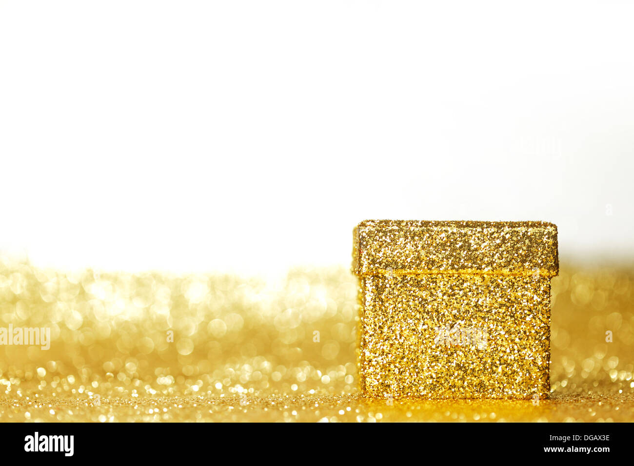 Golden boxes with holiday gifts on shiny glitter background Stock Photo ...