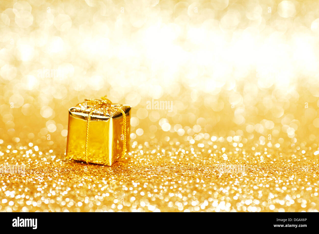 Golden box with christmas gifts on shiny glitter background Stock Photo ...