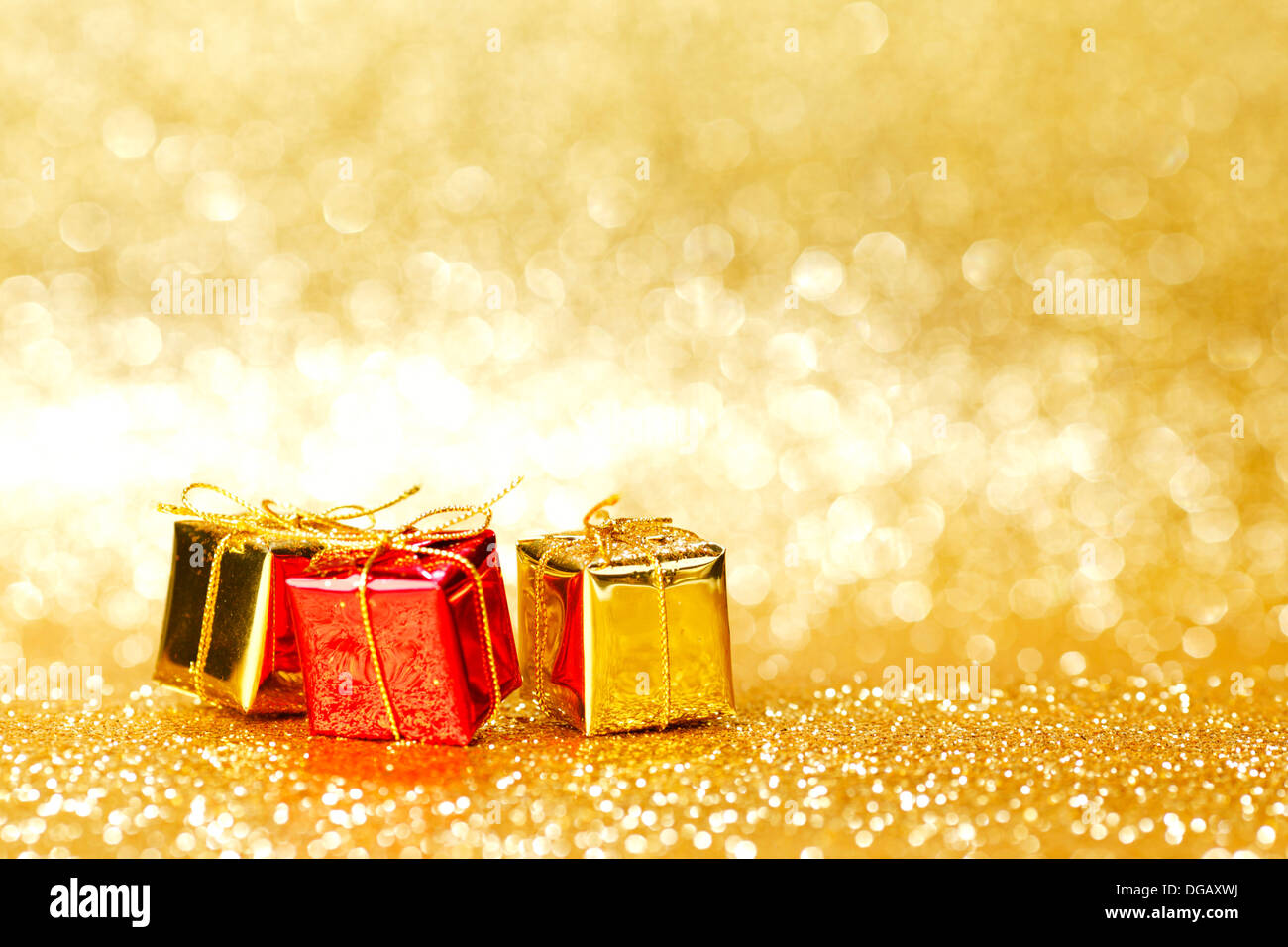 Boxes with christmas gifts on shiny glitter background Stock Photo - Alamy
