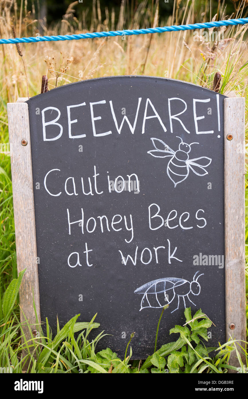 Bee hive warning sign Stock Photo - Alamy