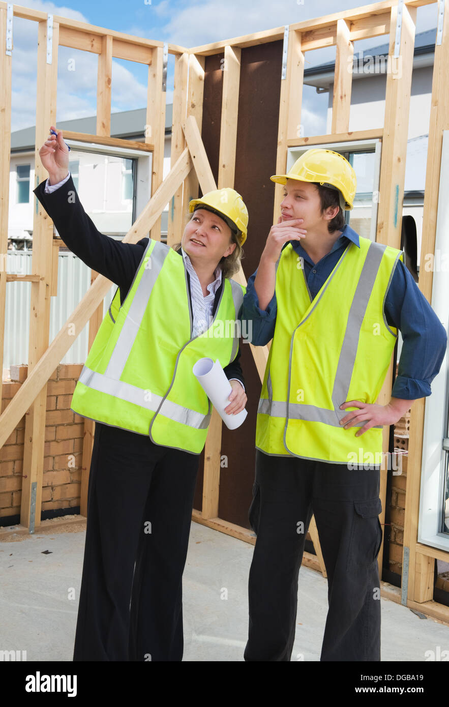 civil engineer and worker discussing issues at the construction site ...