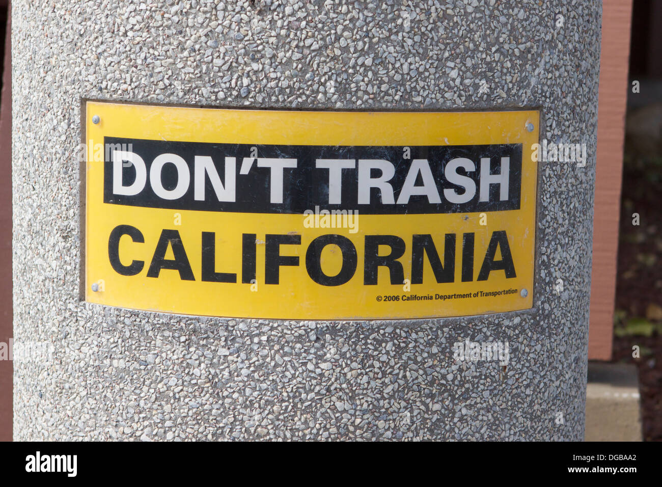 A concrete trash can in California with a sign saying don't trash ...