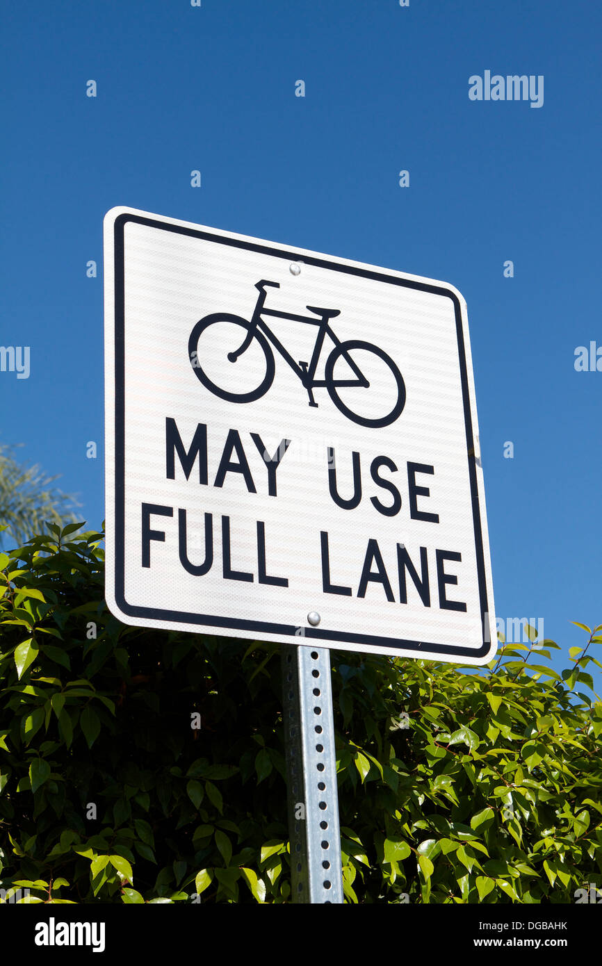 Road sign informing cyclist that they may use the full lane and not ...
