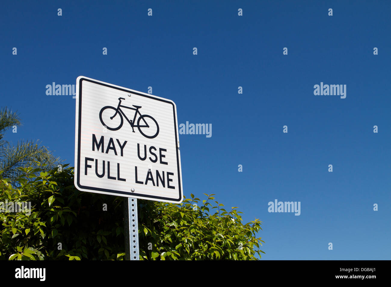 Road sign informing cyclist that they may use the full lane and not ...