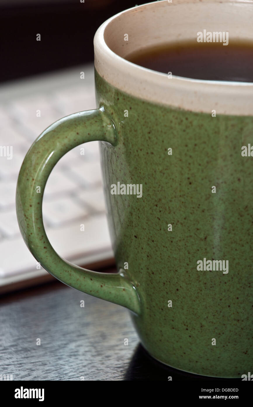 Cup of coffee desk beside a keyboard Stock Photo - Alamy
