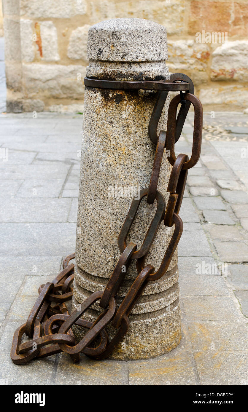 A strong metal chain attached to a bollard, at a quayside Stock Photo ...