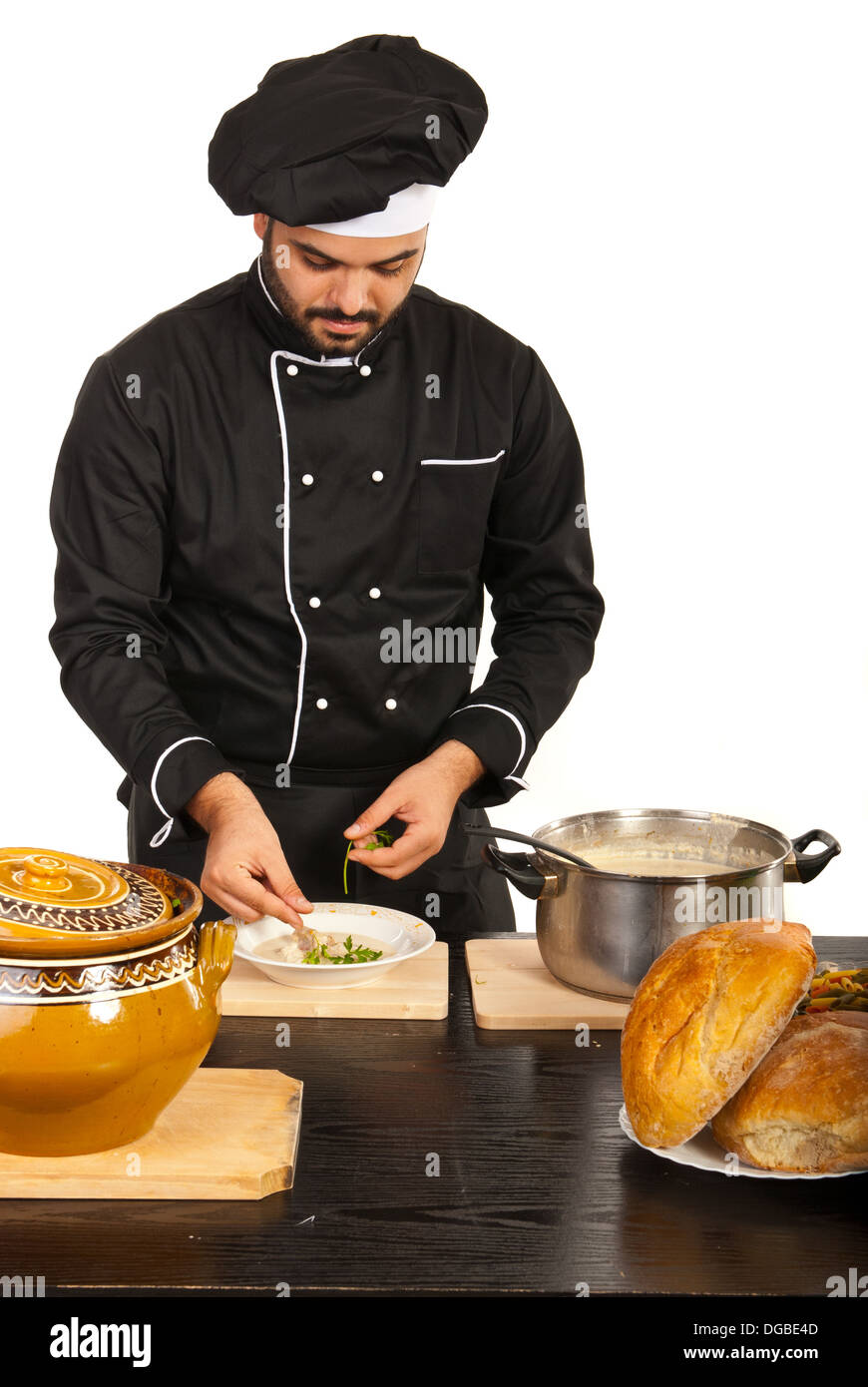 Chef male garnish soup on plate in kitchen Stock Photo - Alamy