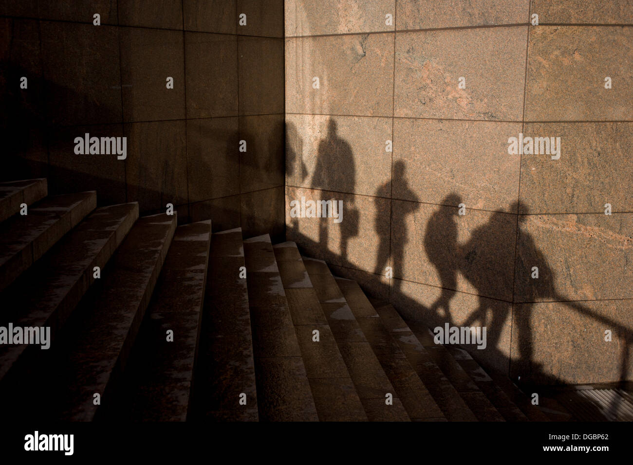 The shadows of anonymous people are seen on a wall in Southwark, on the ...