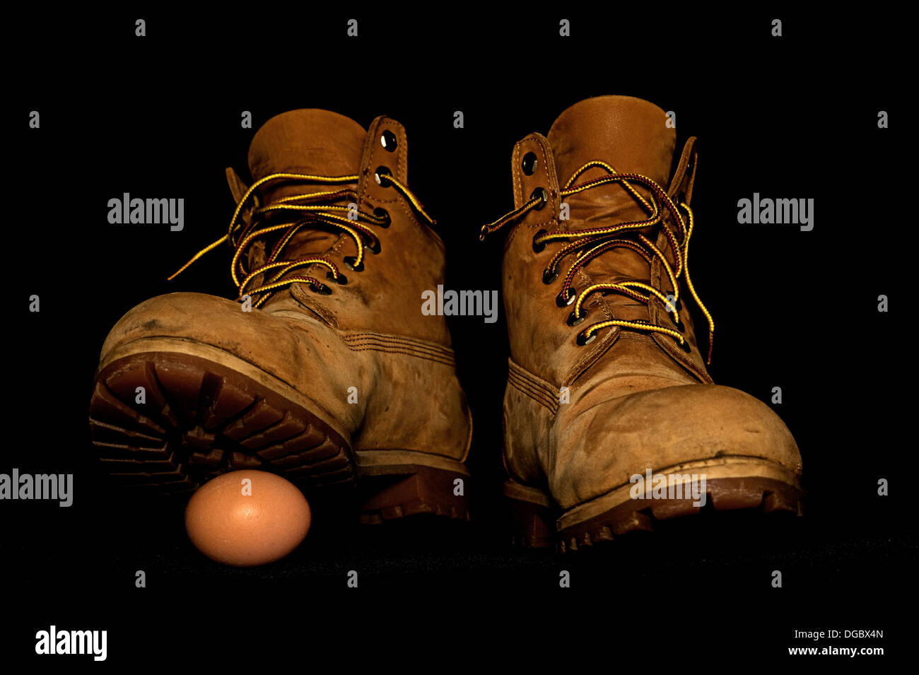 Old boots, and an egg, on black background Stock Photo - Alamy