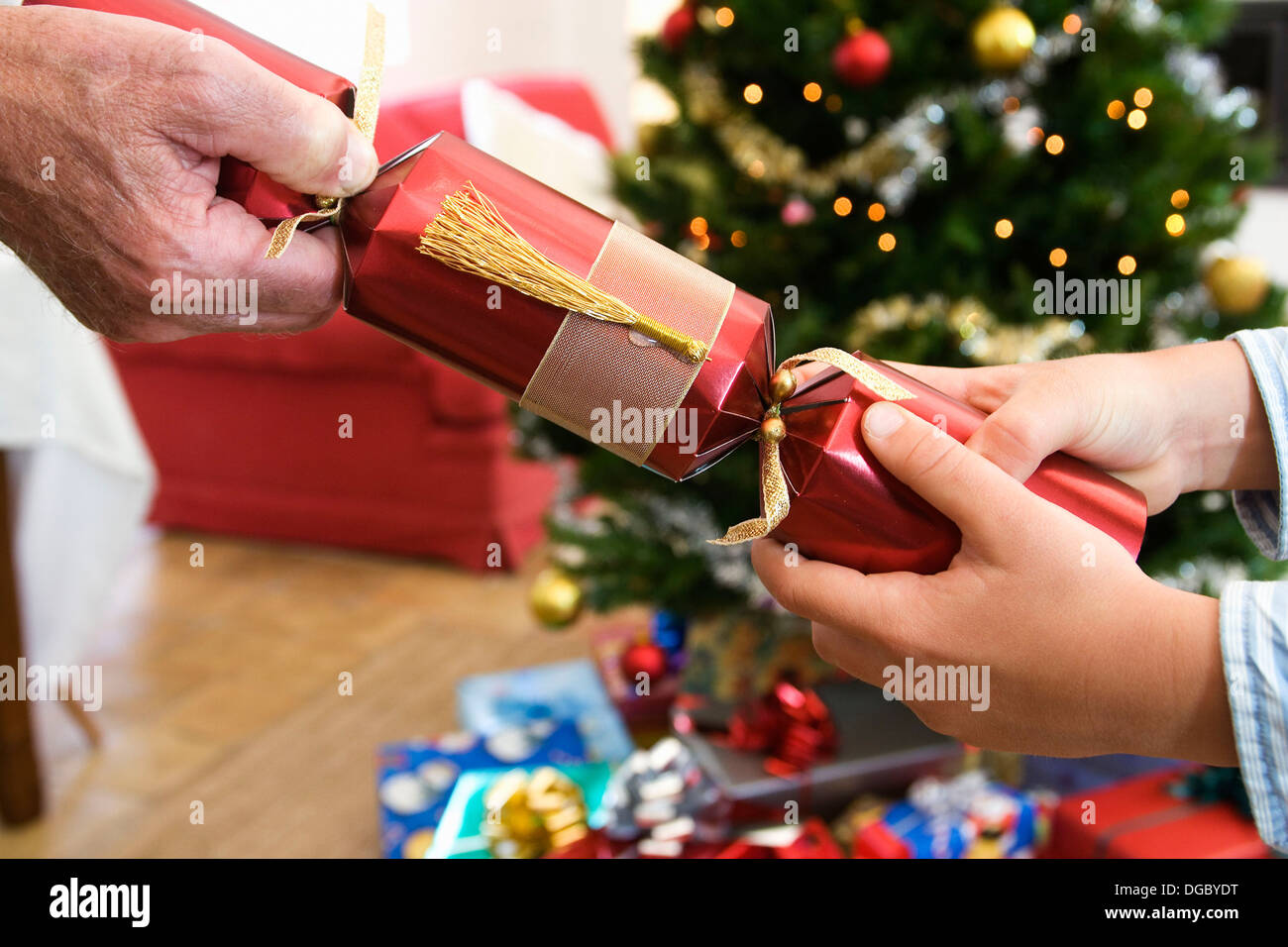 Hand pulling cracker hi-res stock photography and images - Alamy