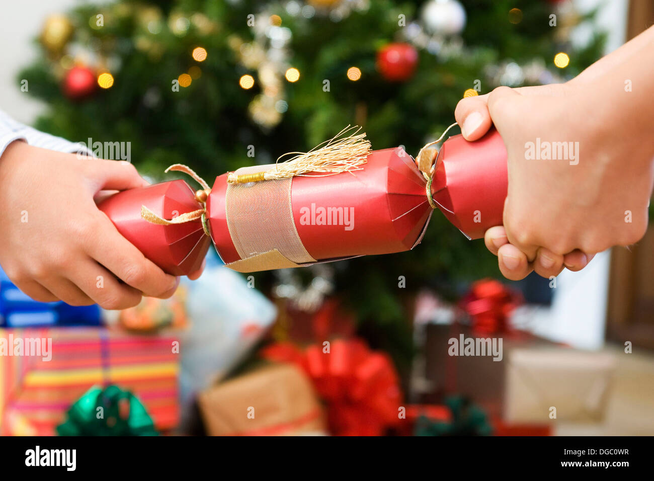 Hand pulling cracker hi-res stock photography and images - Alamy