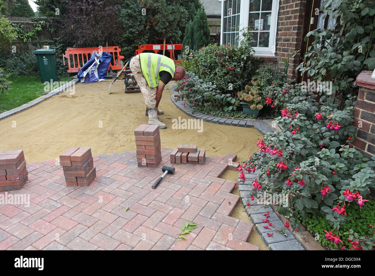 Stage 5 of a project to lay a block paved drive.Lying the blocks on ...