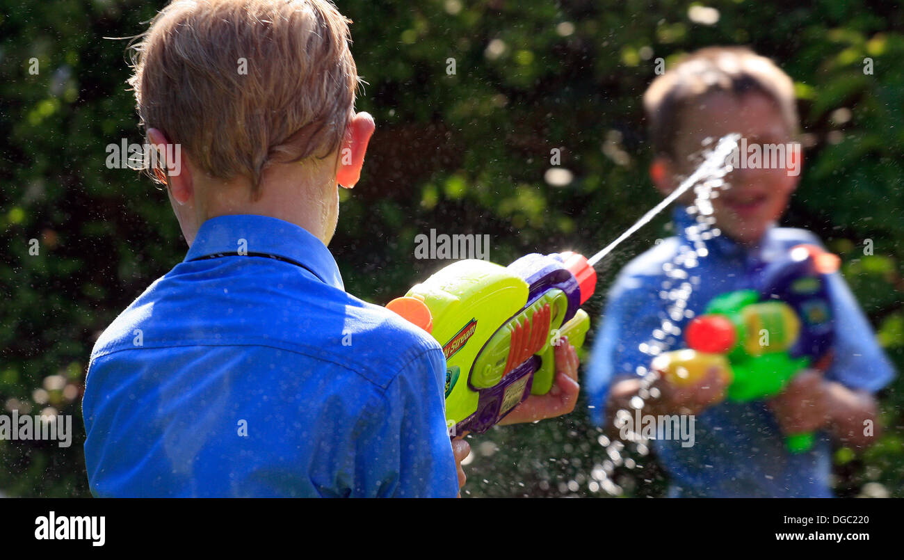 Boys having water fight with water pistols Stock Photo - Alamy