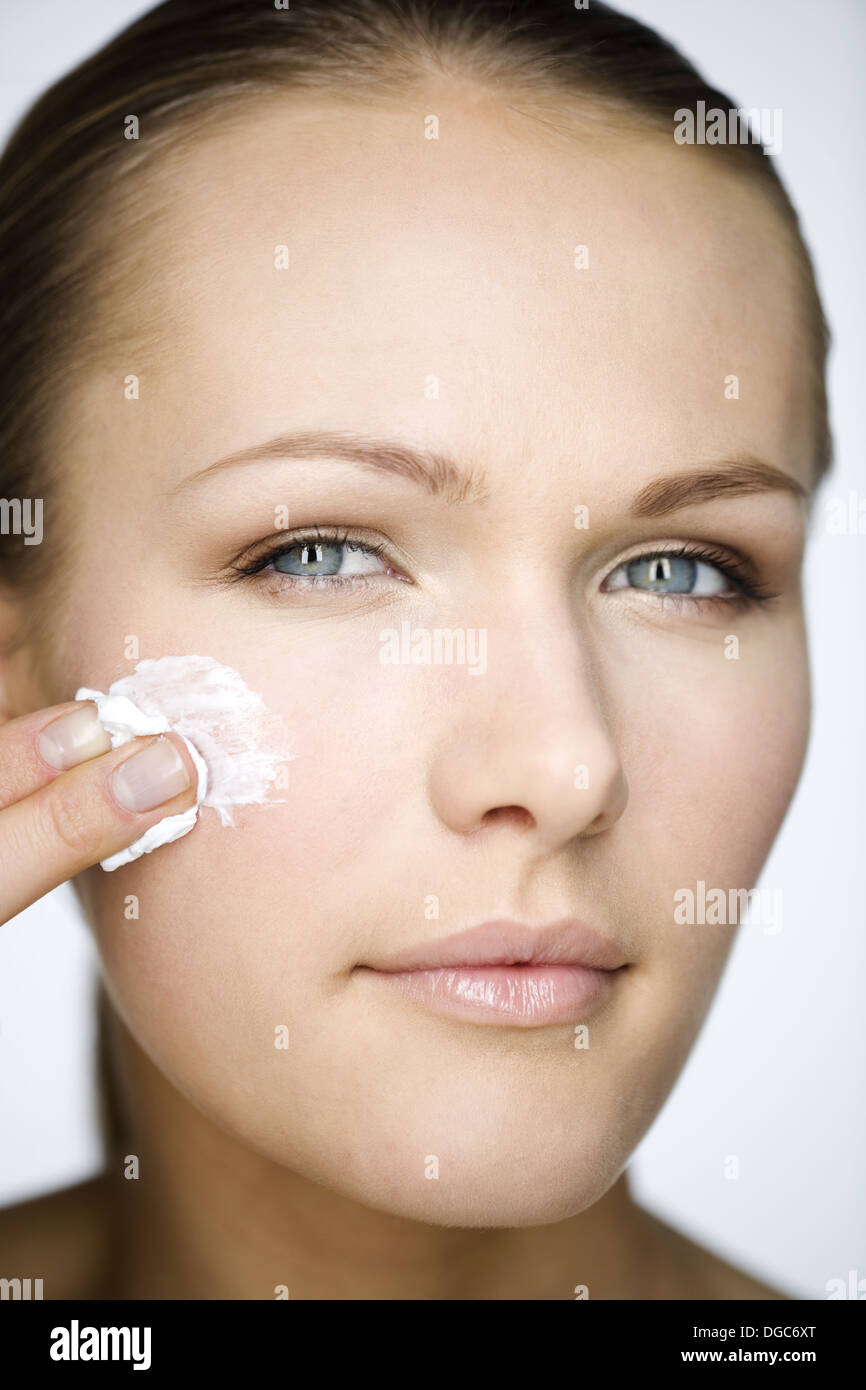 Mid adult woman face cream apply hi-res stock photography and images ...