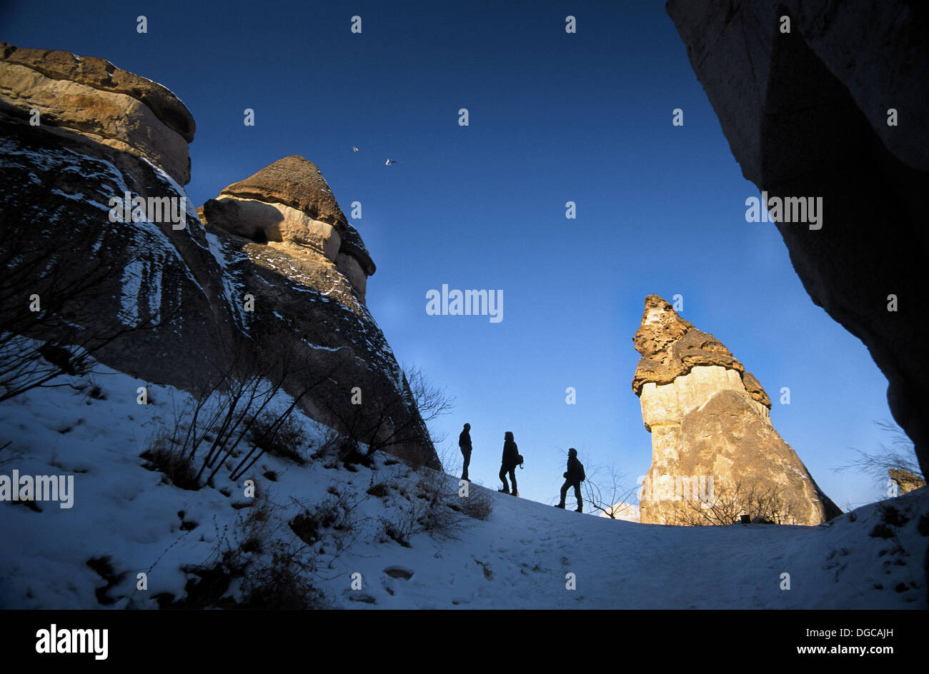 Silhouettes of people between fairy chimneys, Pasabagi, Devrent Valley ...