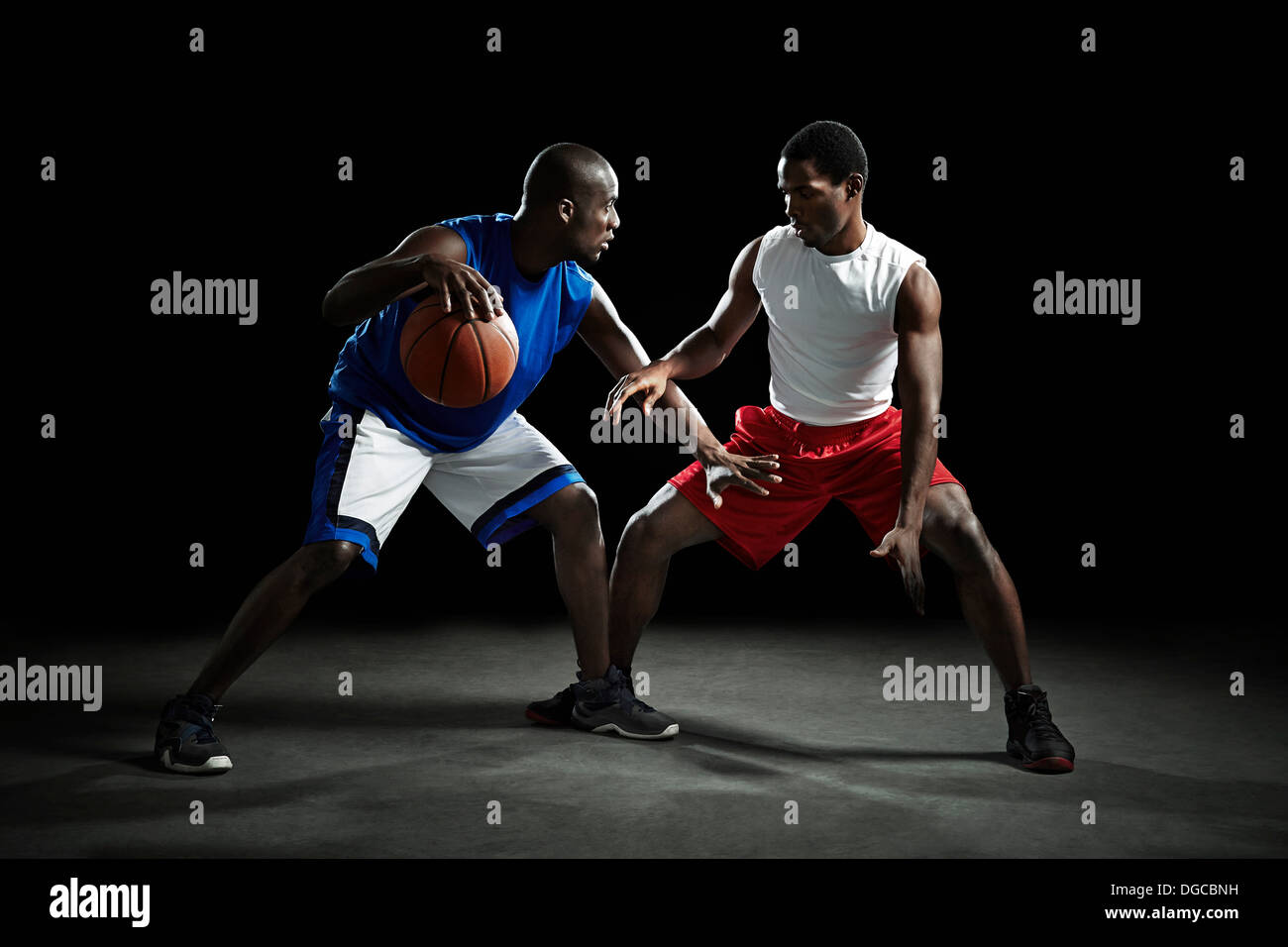 Basketball players competing for ball Stock Photo - Alamy