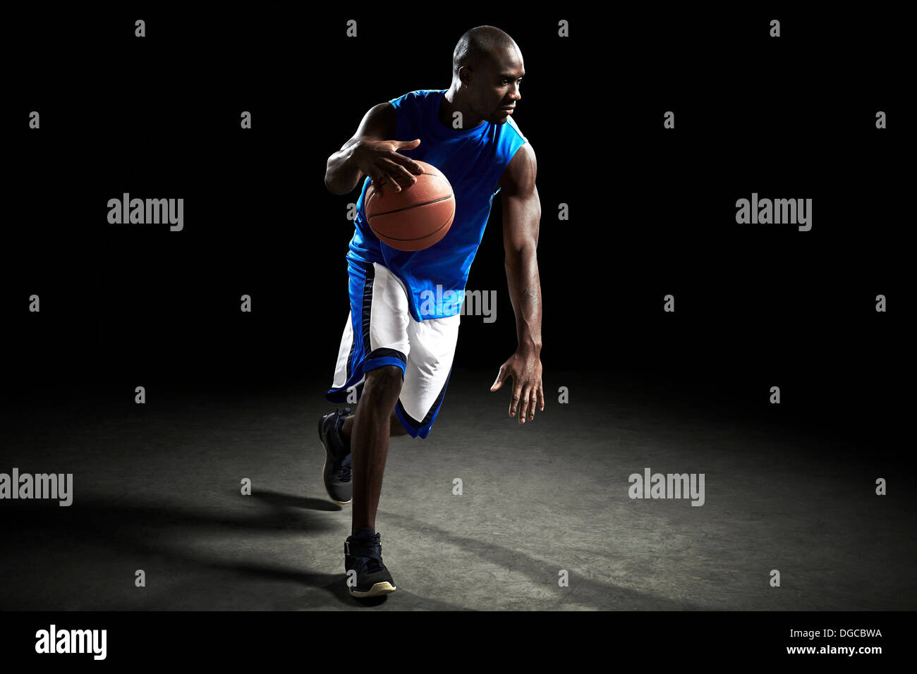 Male basketball player running with ball Stock Photo - Alamy