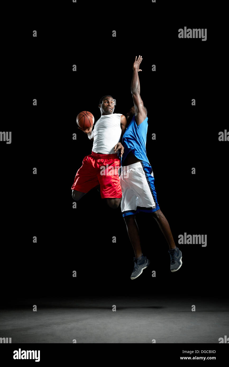 Male basketball players jumping Stock Photo - Alamy
