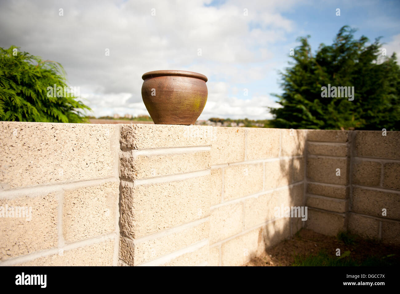 corner of garden wall with plant pot Stock Photo - Alamy