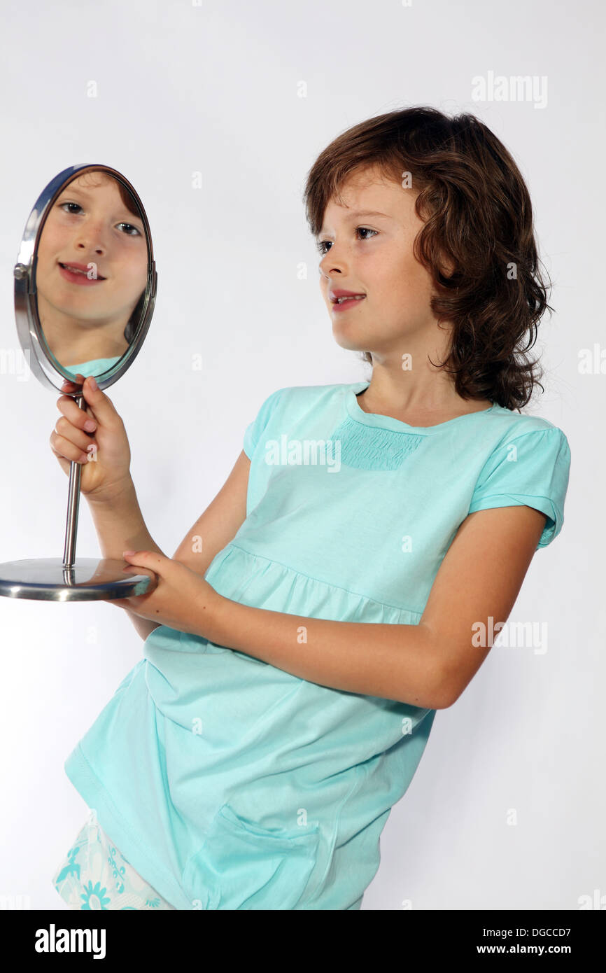 Little girl smiling into a mirror Stock Photo - Alamy