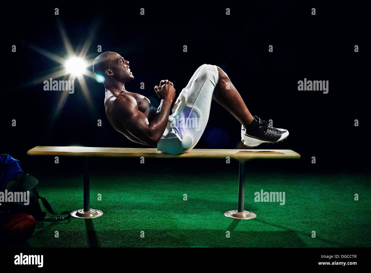 Portrait of american football player doing sit ups Stock Photo - Alamy