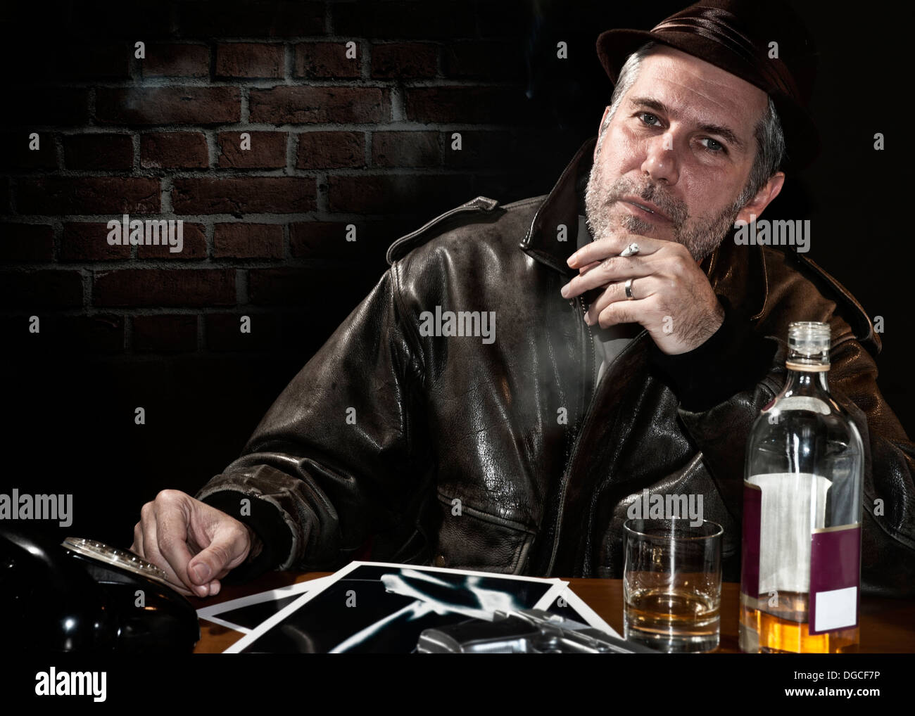 Detective examining evidences in his office Stock Photo - Alamy