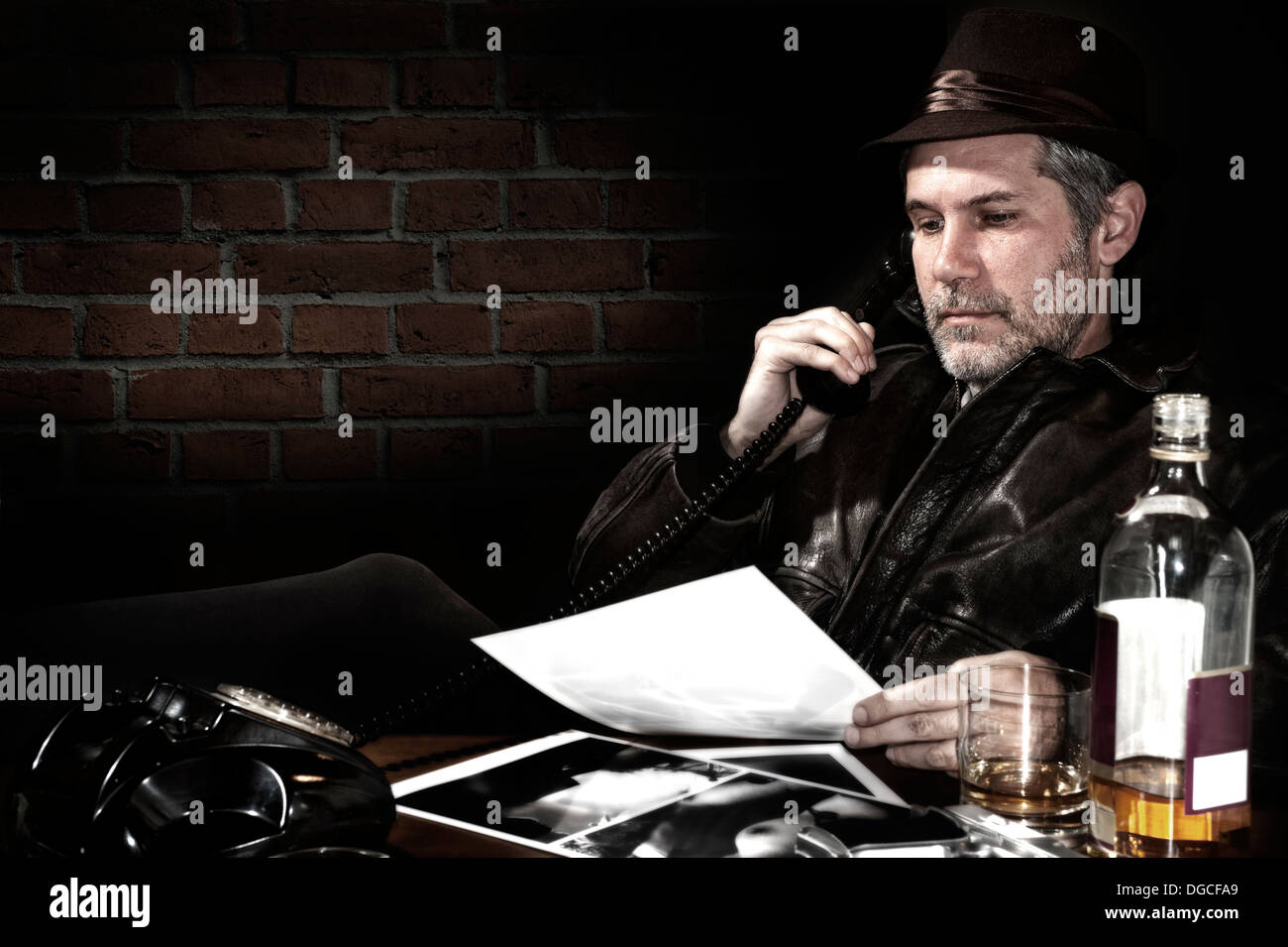 Detective examining evidences in his office Stock Photo - Alamy