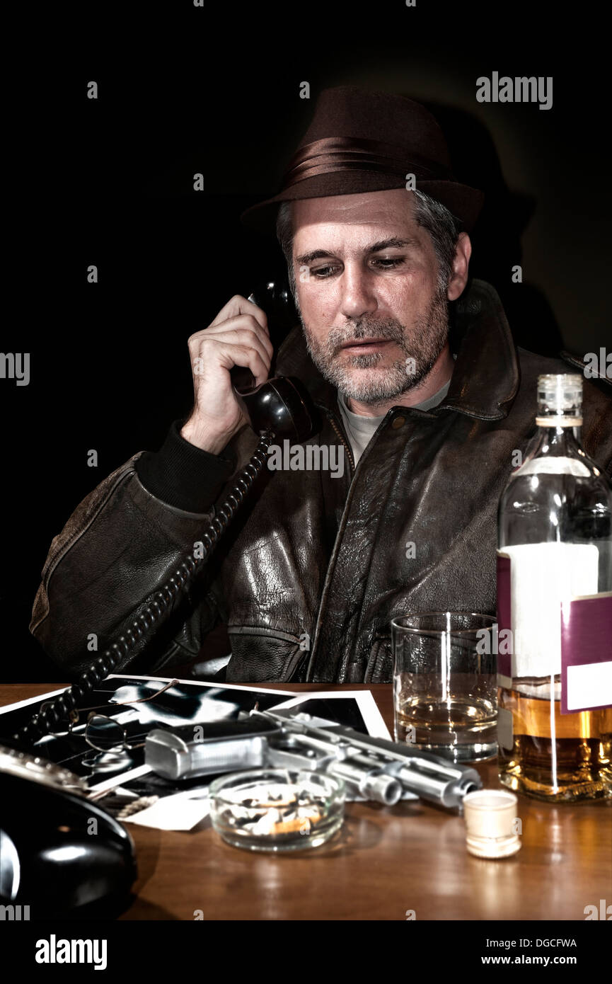 Detective examining evidences in his office Stock Photo - Alamy