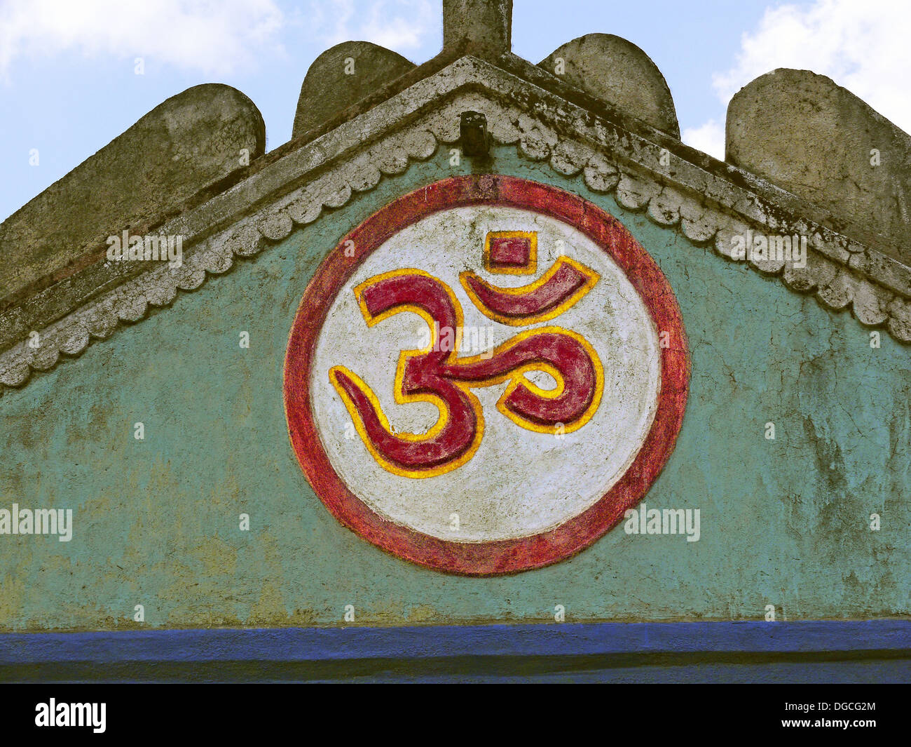 A holy sign called om is painted on front side of a Hindu temple roof ...