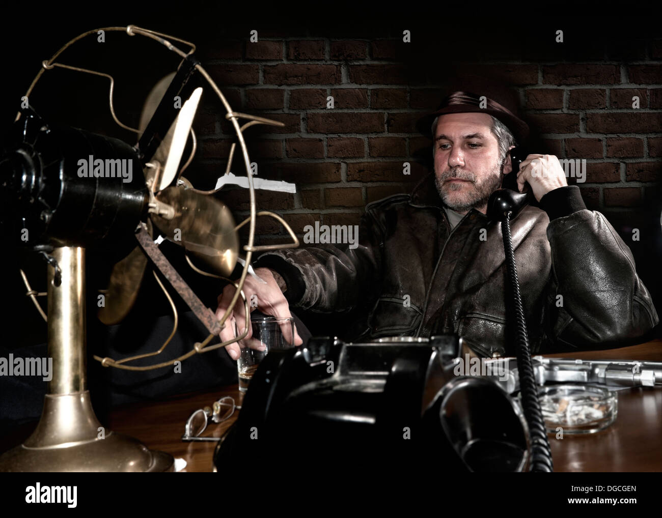 Detective examining evidences in his office Stock Photo - Alamy