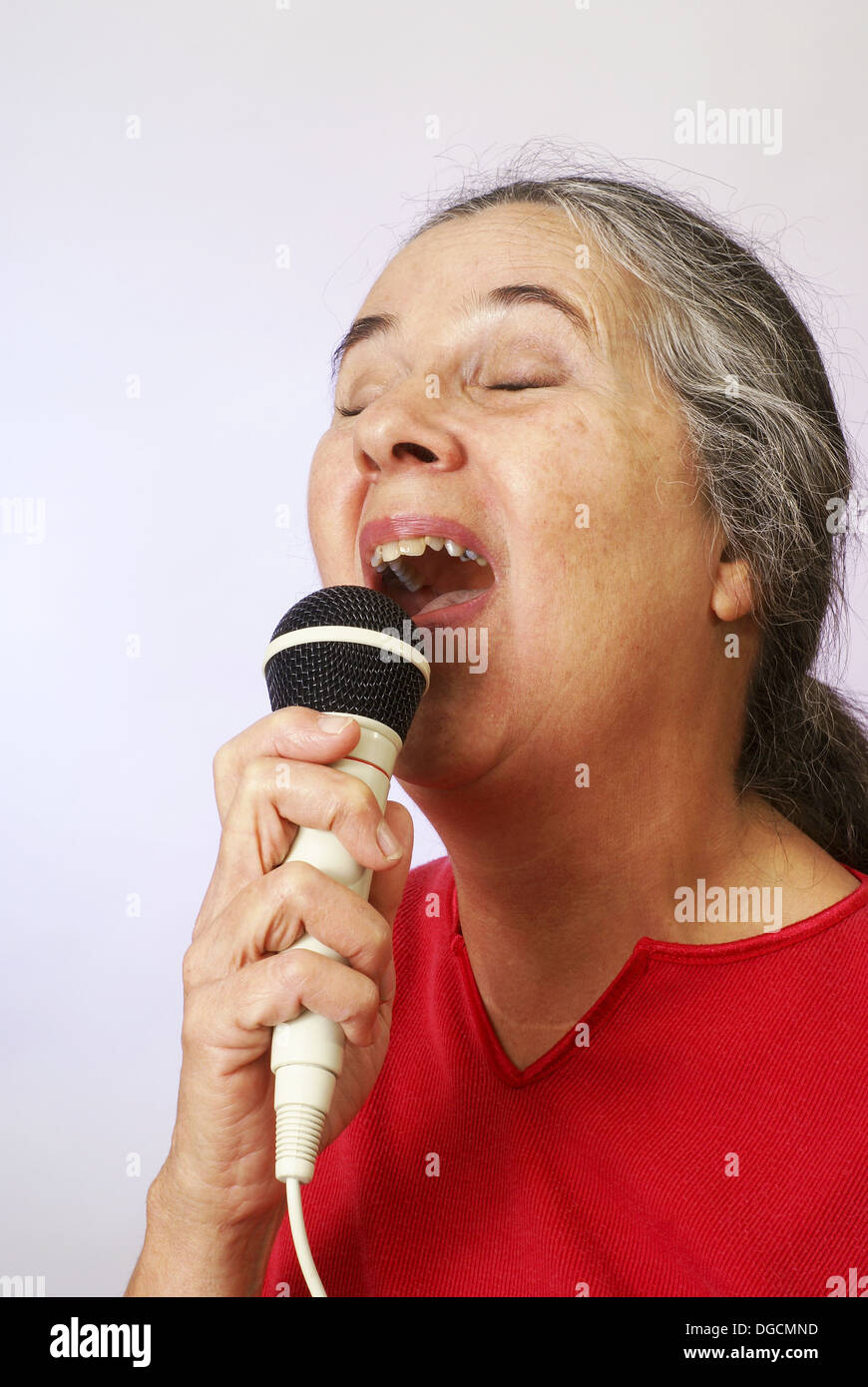 Old woman singing hi-res stock photography and images - Alamy